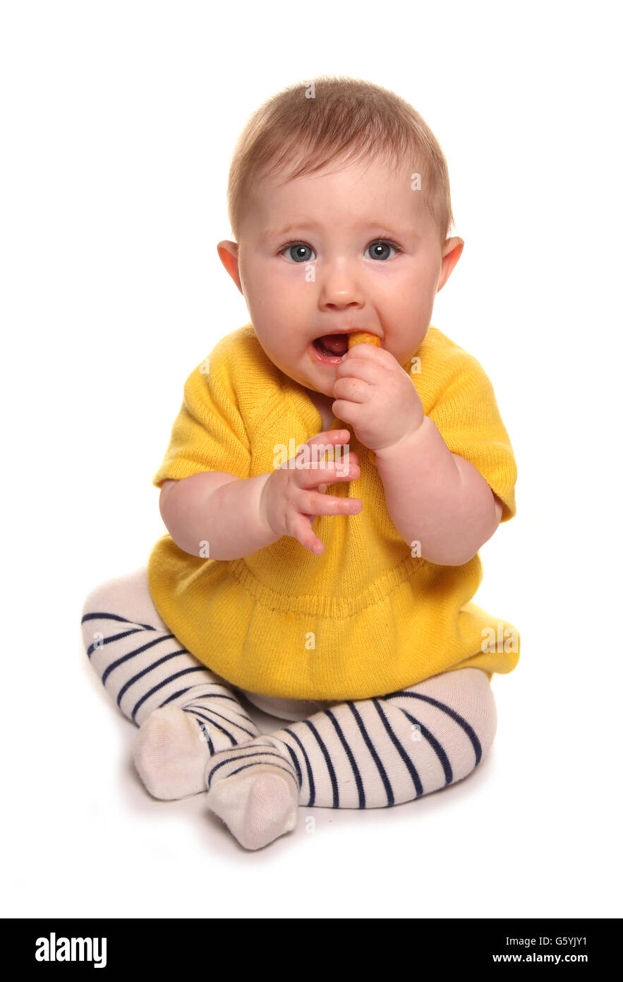 Baby girl eating finger food cutout Stock Photo - Alamy