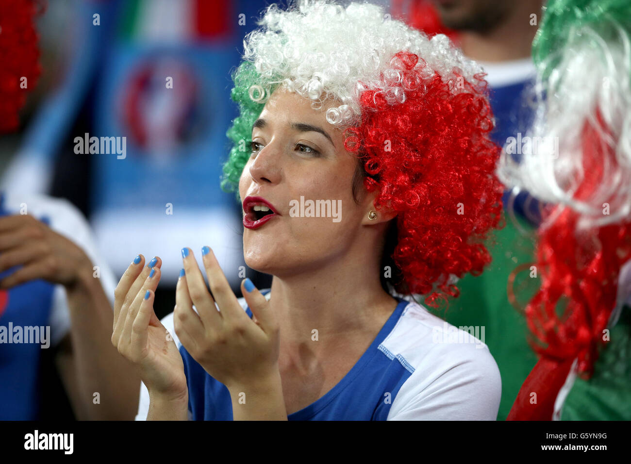 Italy fans wearing wigs cheer on their side in the stands before the ...