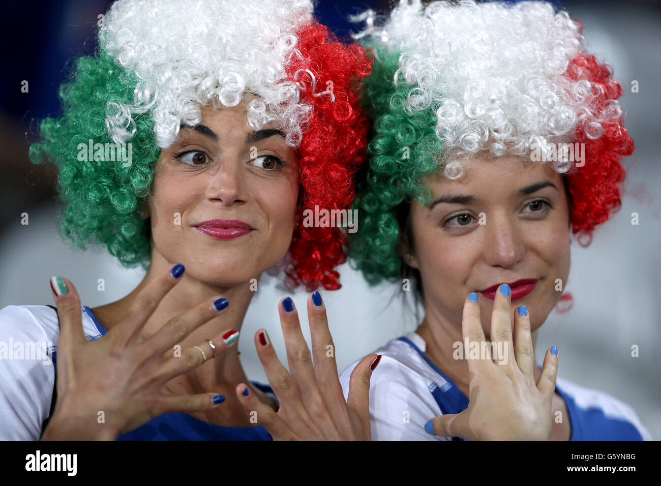 Italy fans wearing wigs cheer on their side in the stands before the ...