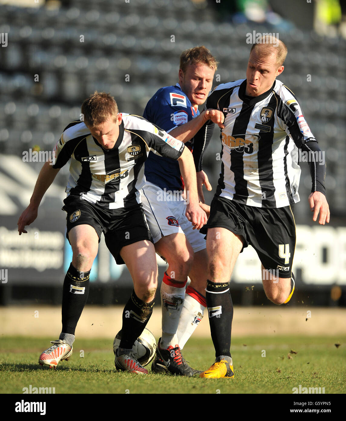 Notts County's Jeff Hughes (left) and Neal Bishop crowd out Carlisle ...