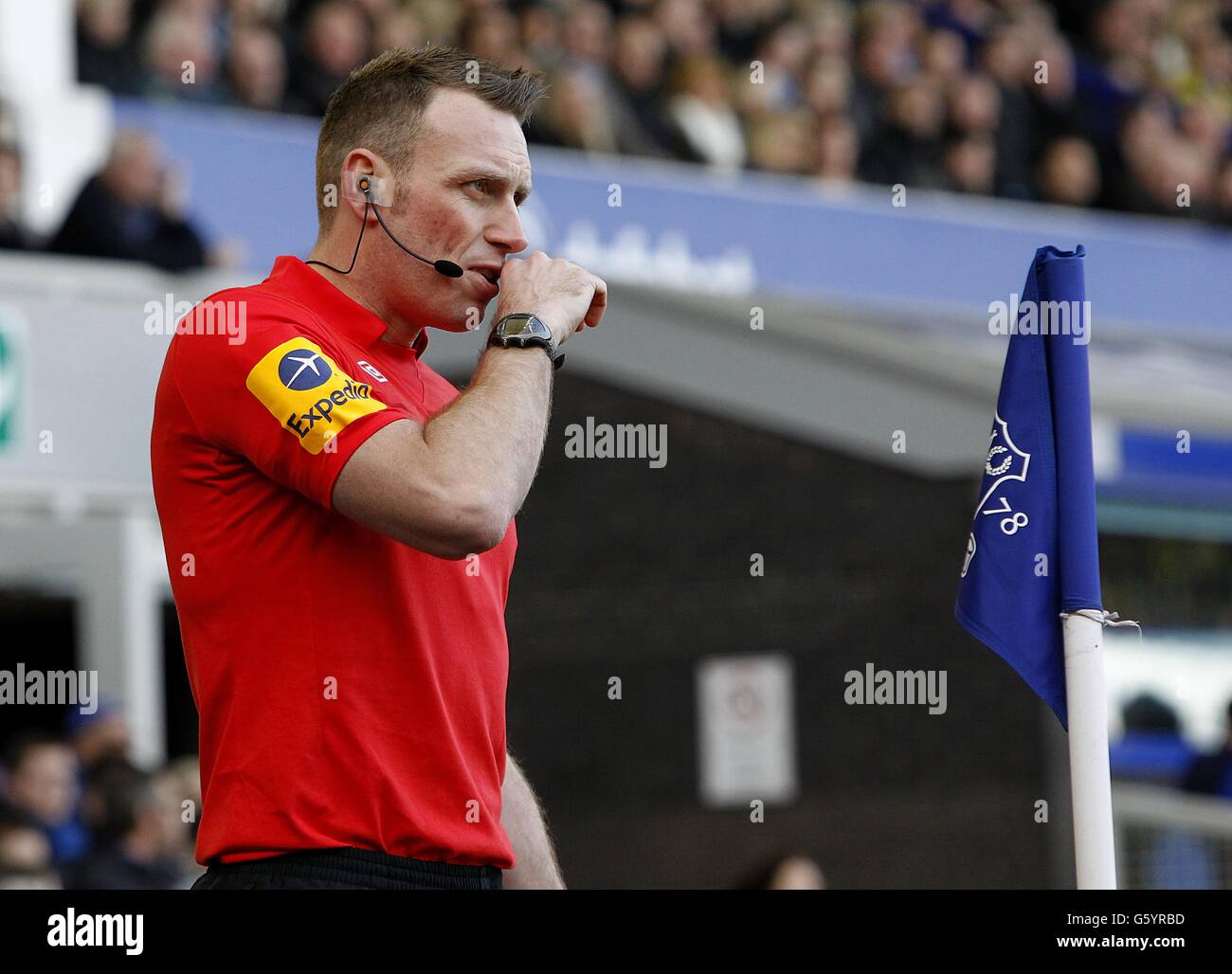 An assistant referee talks through his mic to the referee hi-res stock ...