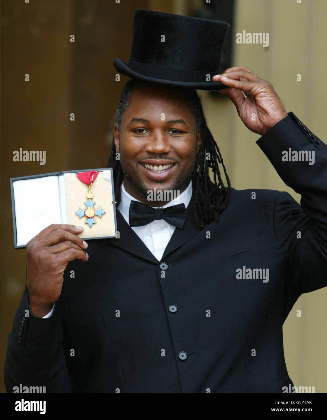 World heavyweight boxing champion Lennox Lewis holds his Commander of ...