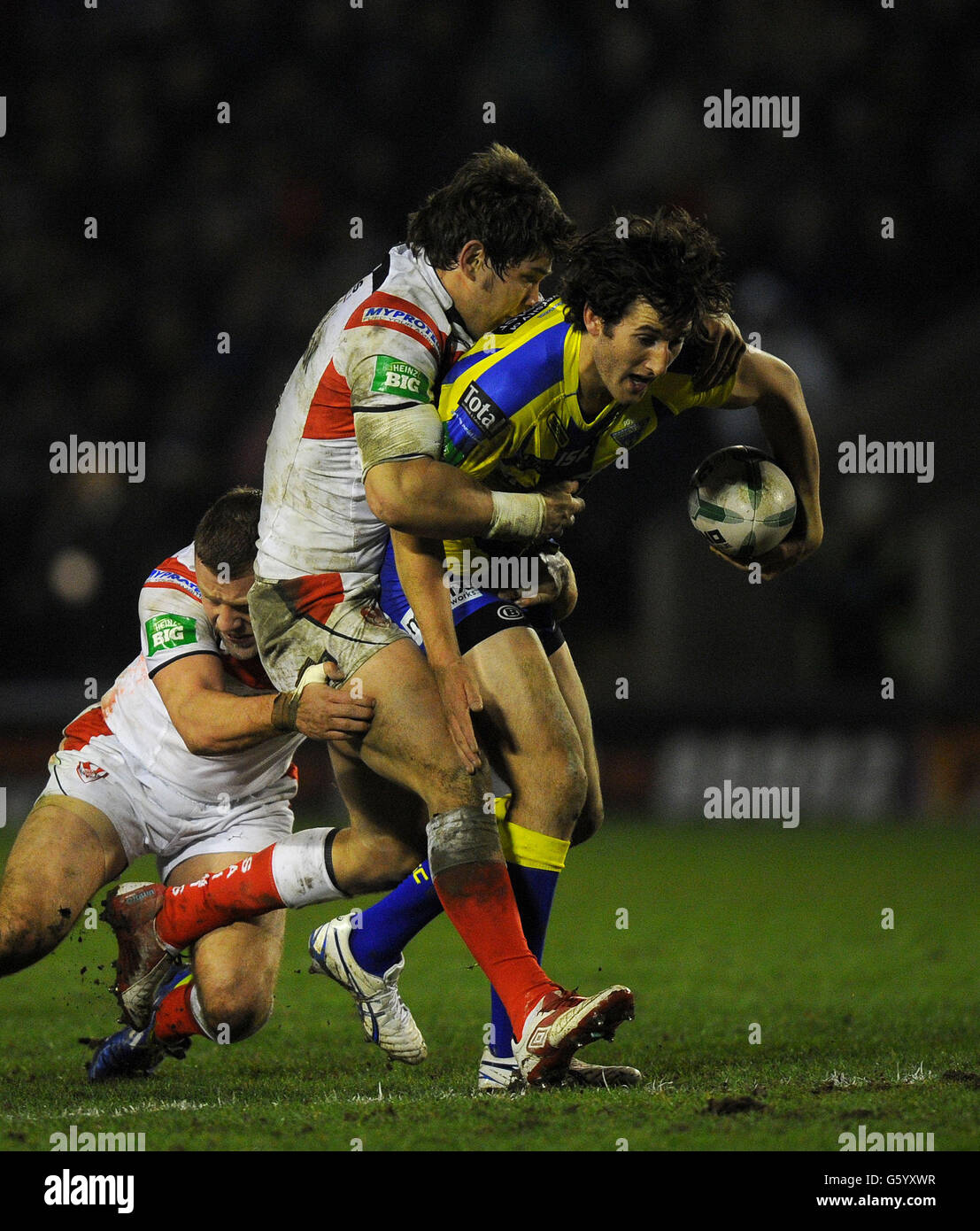 Warrington Wolves' Stefan Ratchford is tackled by St Helens Louie ...
