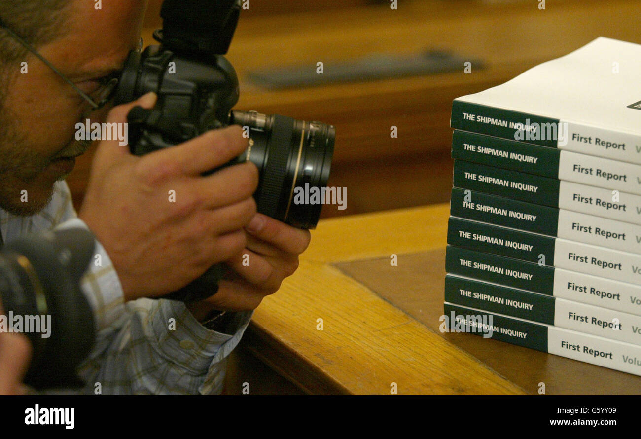 A photographer takes a picture of a stack of reports into serial killer ...