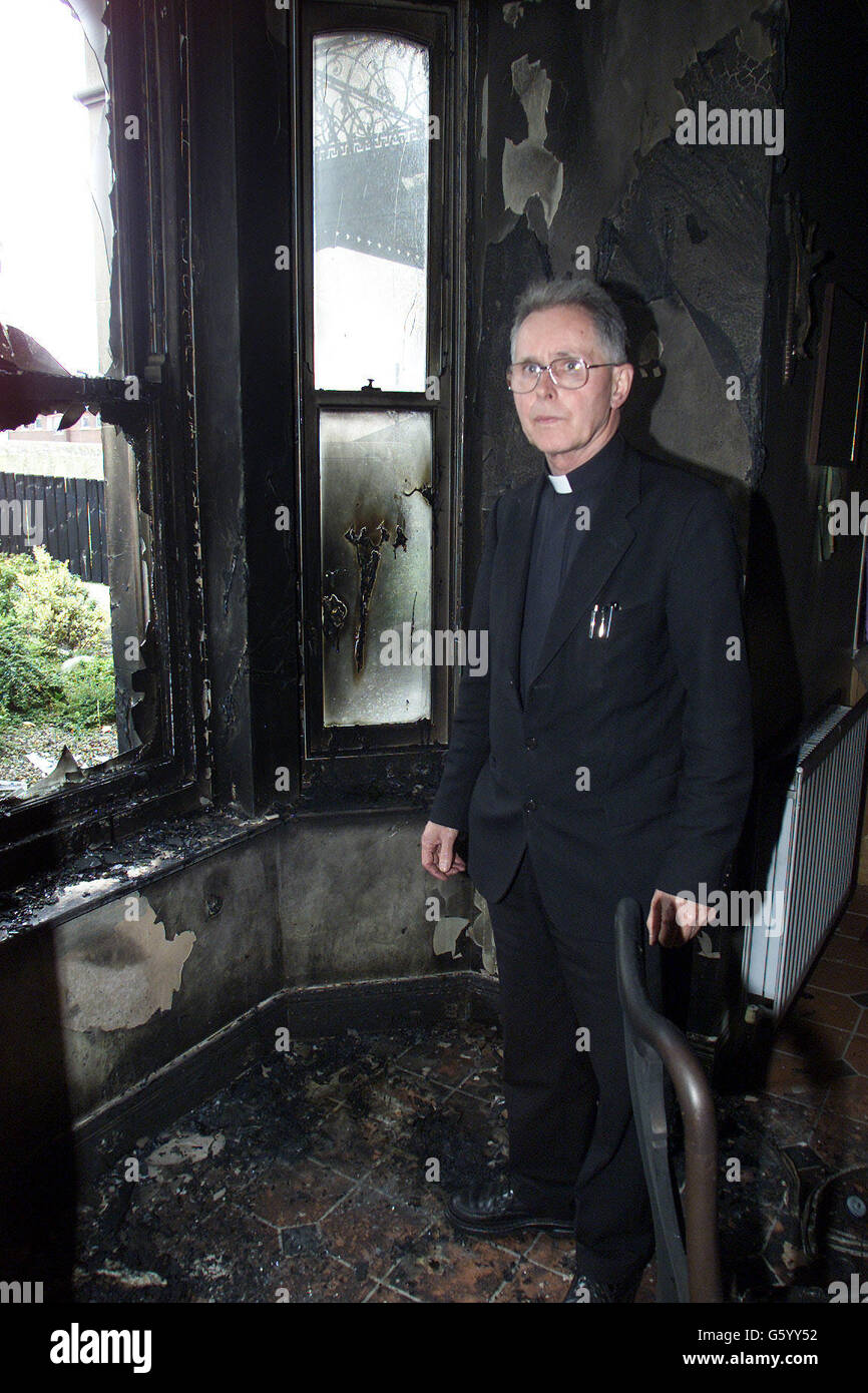 Father Albert McNally inspects the damage to the burnt-out kitchen area ...