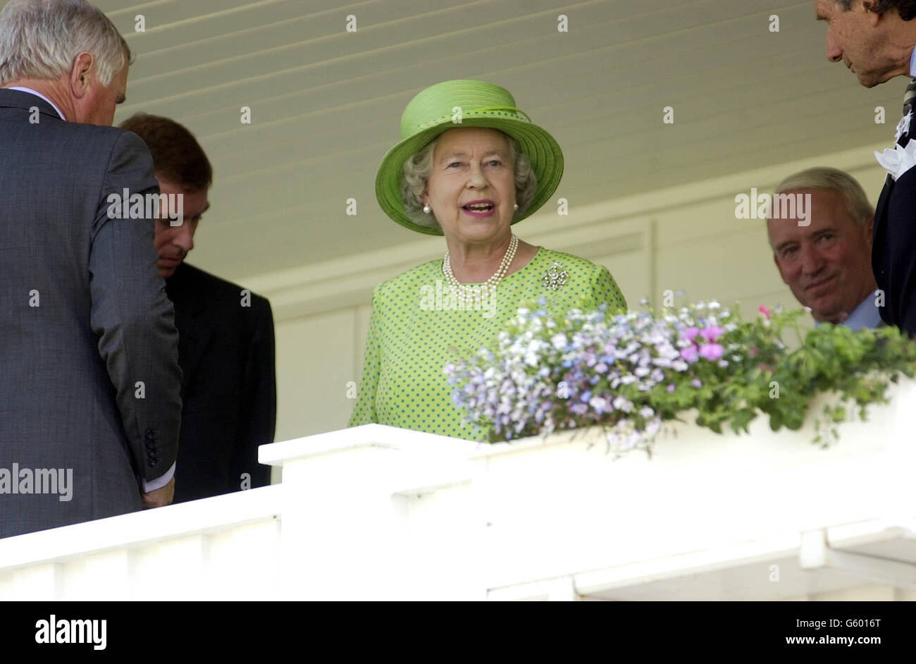 Britain's Queen Elizabeth II catches a glimpse of the Coronation Cup ...