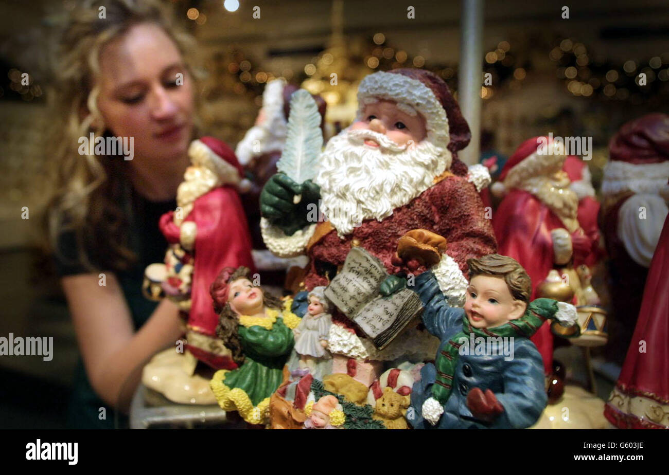 A shop assistant puts the final touches to Christmas decorations in the ...