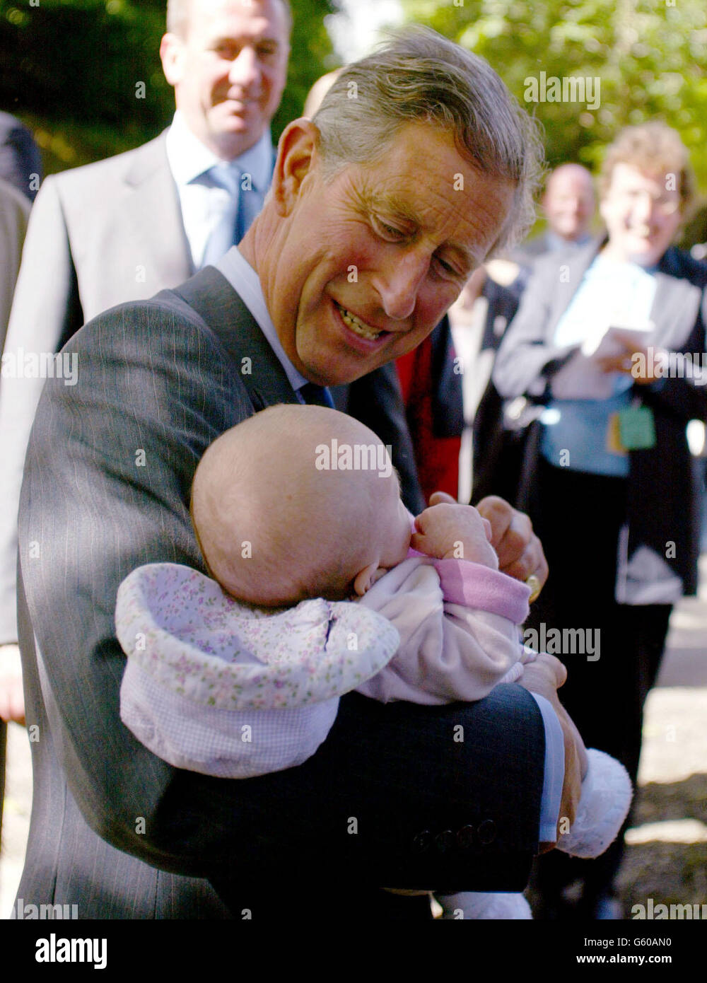 Prince Charles with a baby in Wales. The Prince of Wales, holds 7 week ...