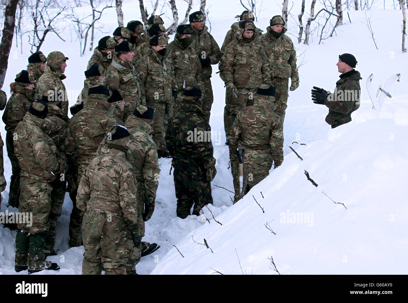 Marines are given instructions on how to dig snow holes to camp in, as ...