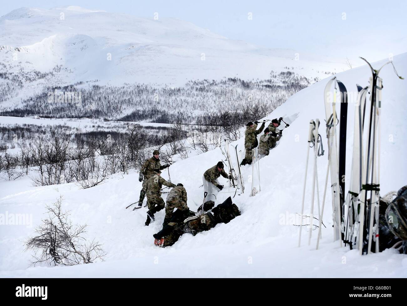 Marines collapse their snow holes they had built, as troops take part ...