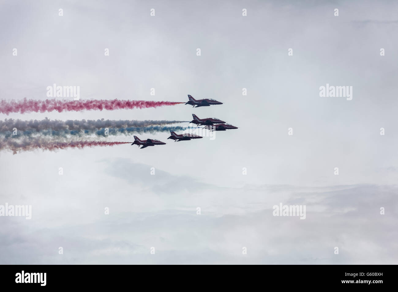 RAF Red Arrows Hawk Jets flying in formation with smoke trails behind ...