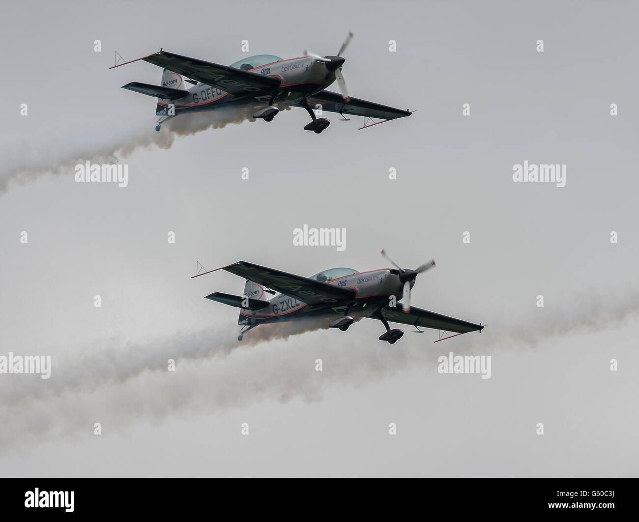 Two planes from the Blades Aerobatic Display team flying with white ...