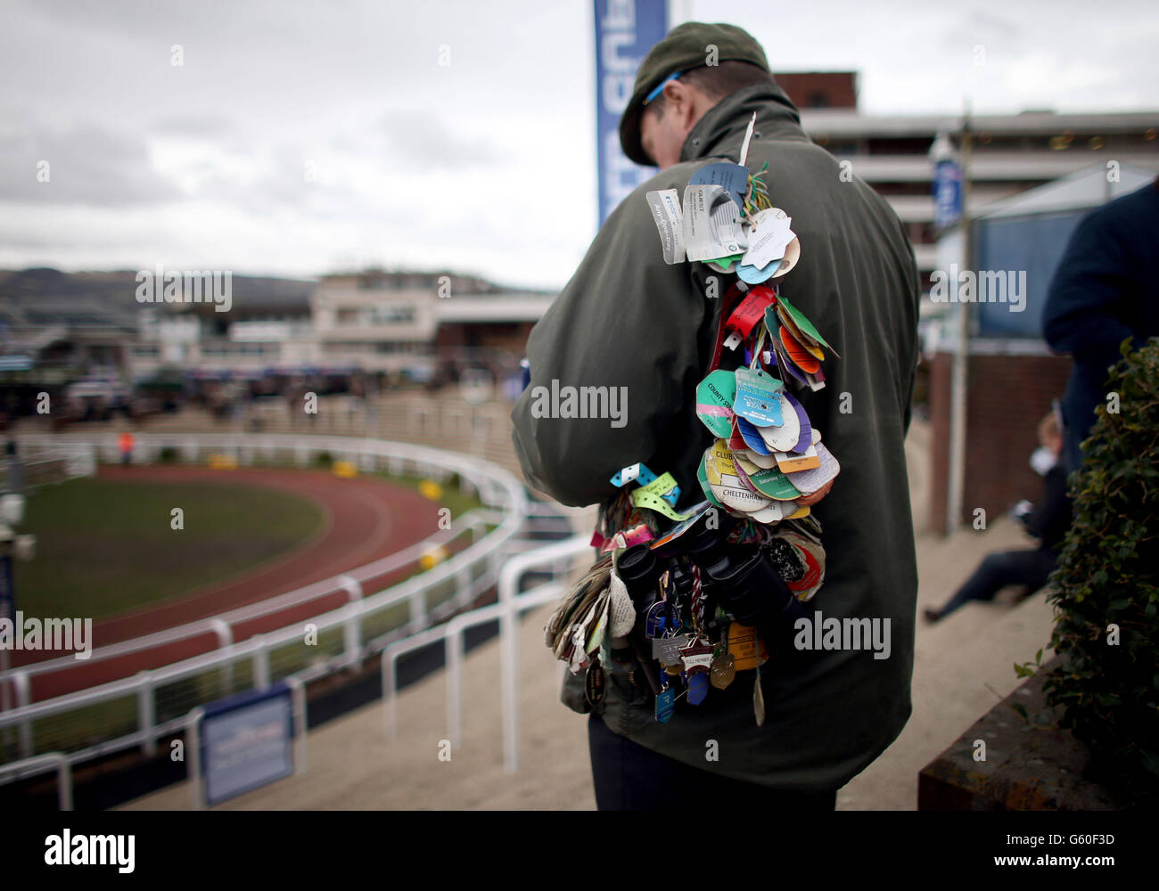 A race goer waits by the parade ring during the Cheltenham Gold Cup Day ...