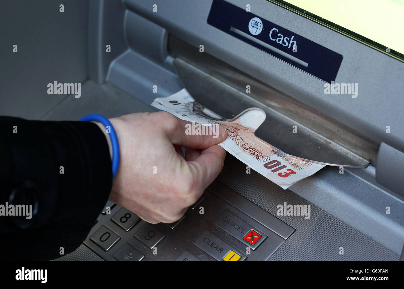 Money being taken out cash machine hi-res stock photography and images ...