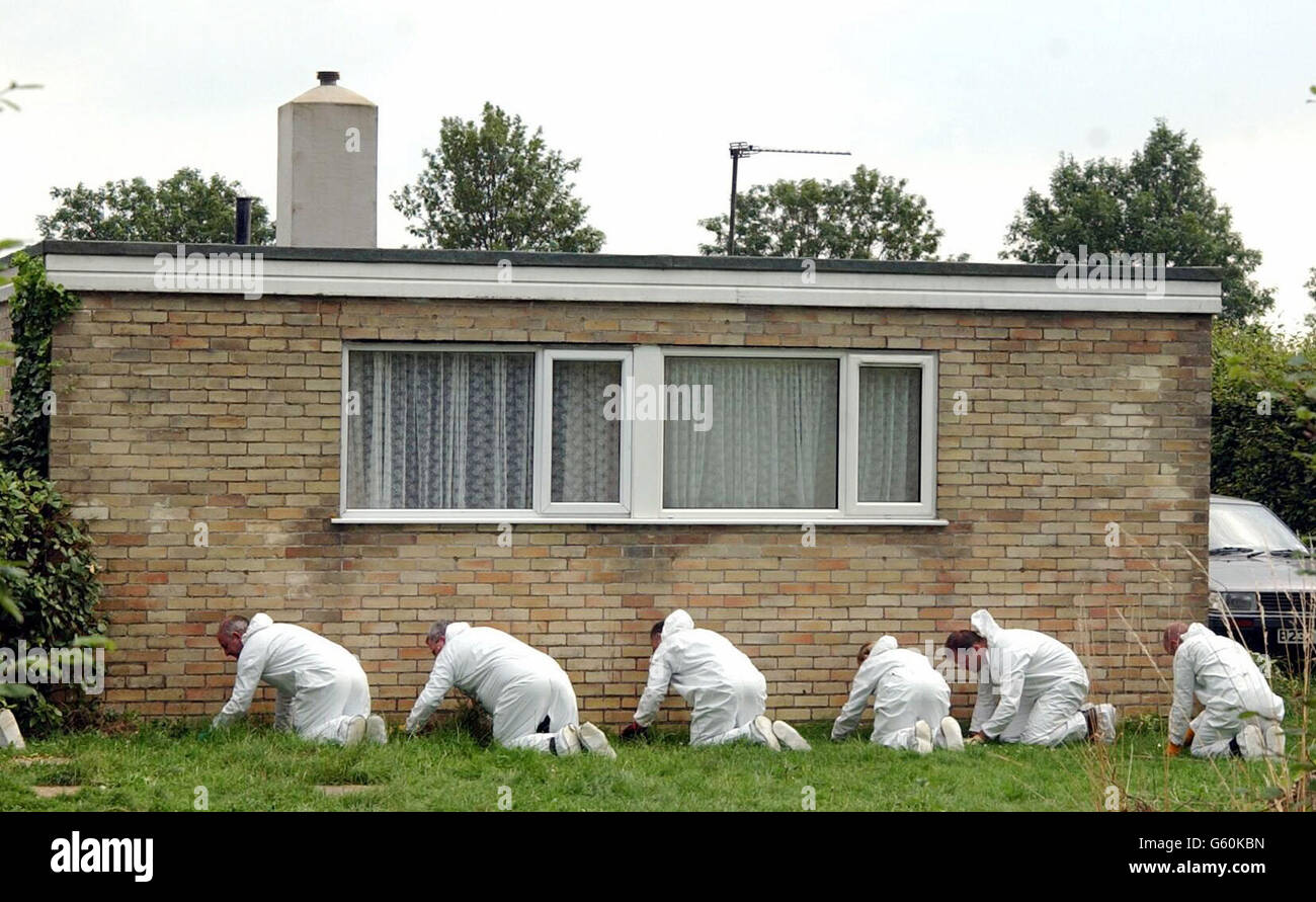 Specialist teams conduct a fingertip search outside the house of Kevin ...