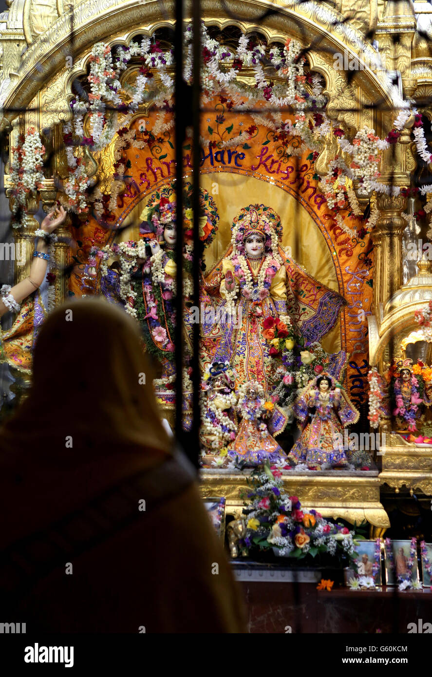 A woman prays in front of a shrine at the Bhaktivedanta Manor Krishna ...