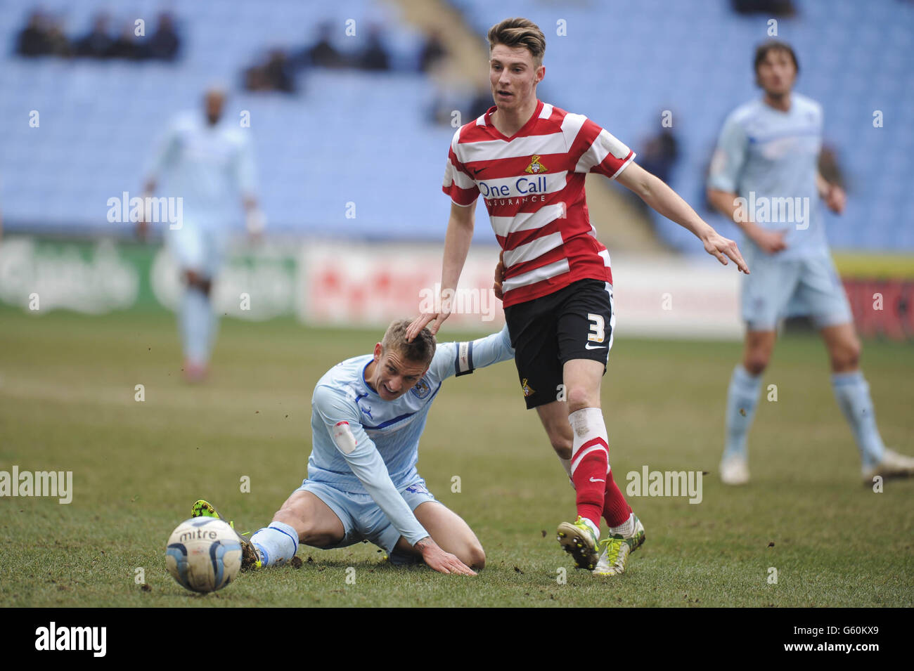 Coventry City's Carl Baker is challenged by Doncaster Rovers James ...