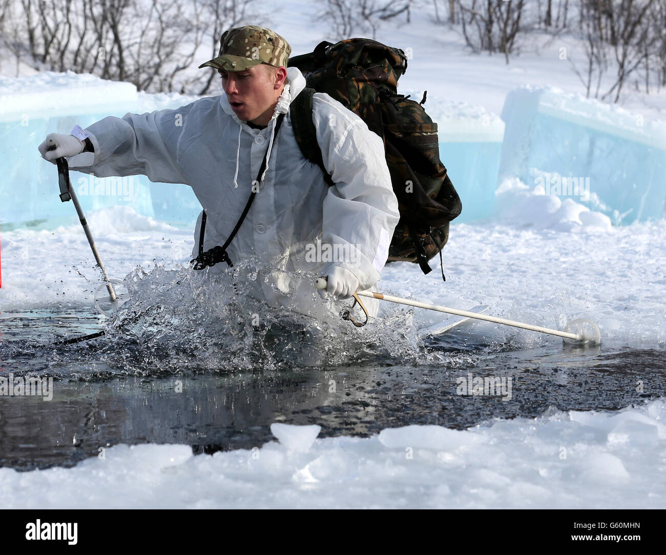 A Marine plunges into the ice cold water during the ice breaking drill ...