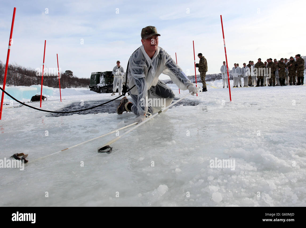 A Marine pulls himself from the ice cold water during the ice breaking ...