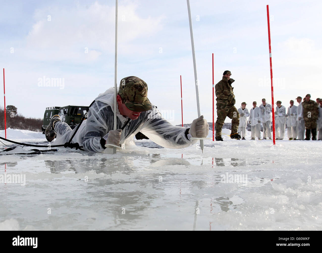 A Marine pulls himself from the ice cold water during the ice breaking ...