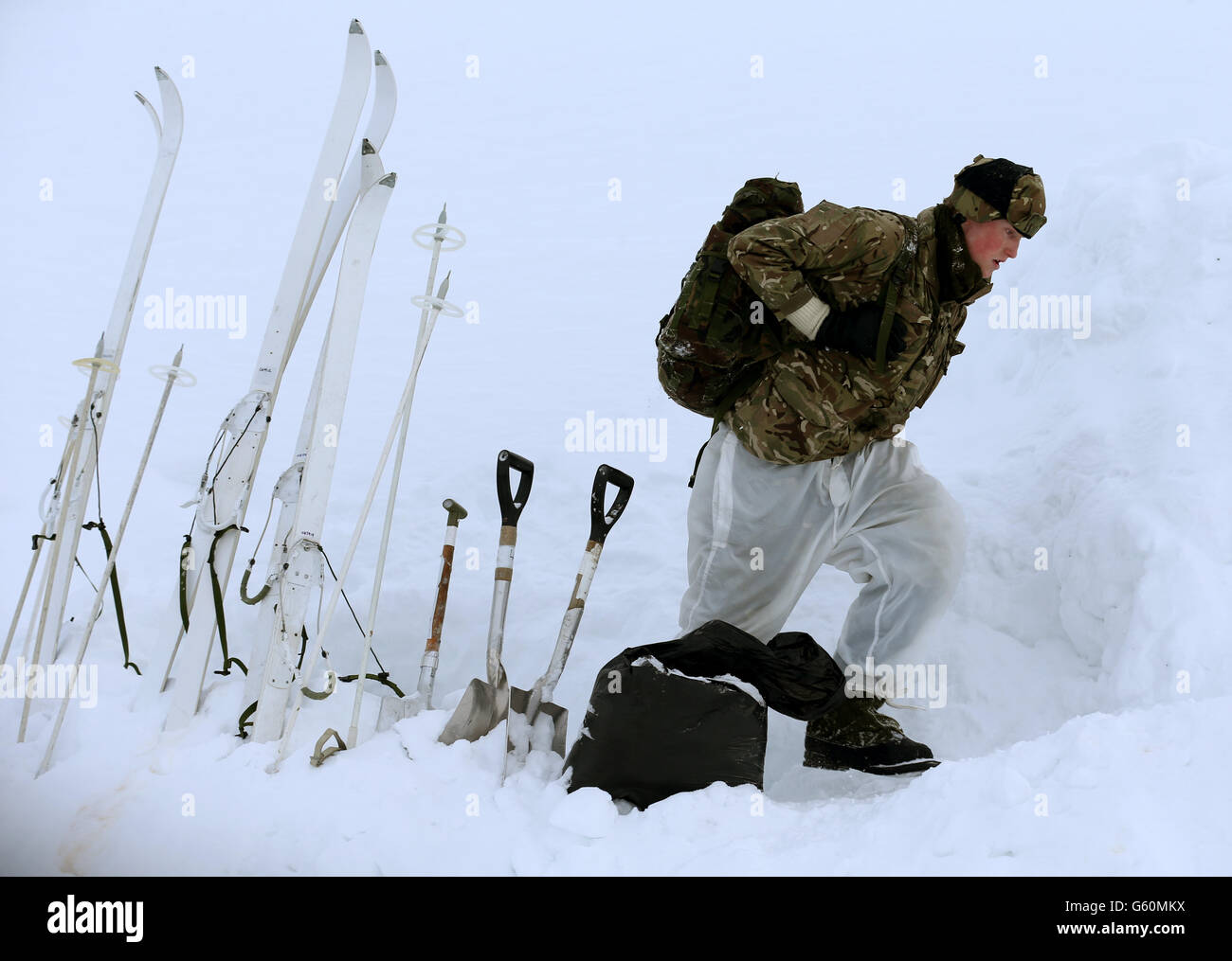 A marine leaves his snow hole training during Exercise Hairspring 2013 ...