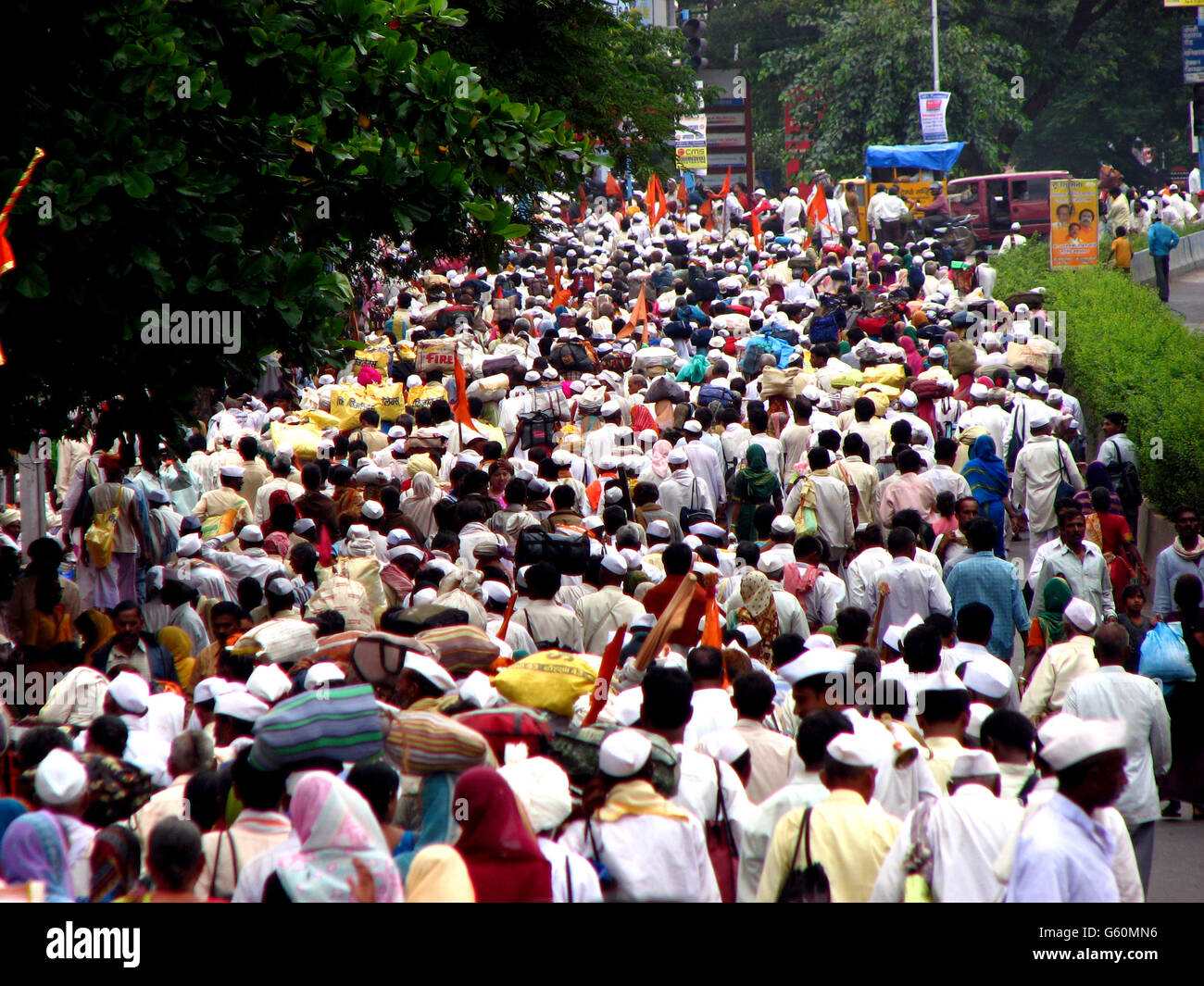 Thousands of hindu pilgrims migrating to a pilgrimmage through the city ...