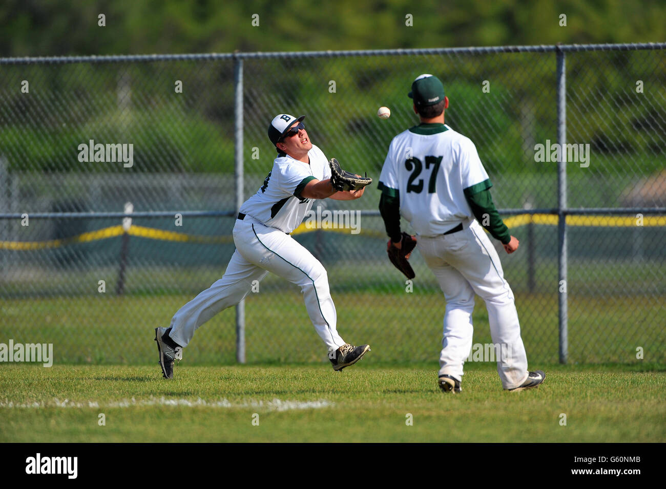 First baseman making a running catch of a pop foul on the first pitch ...