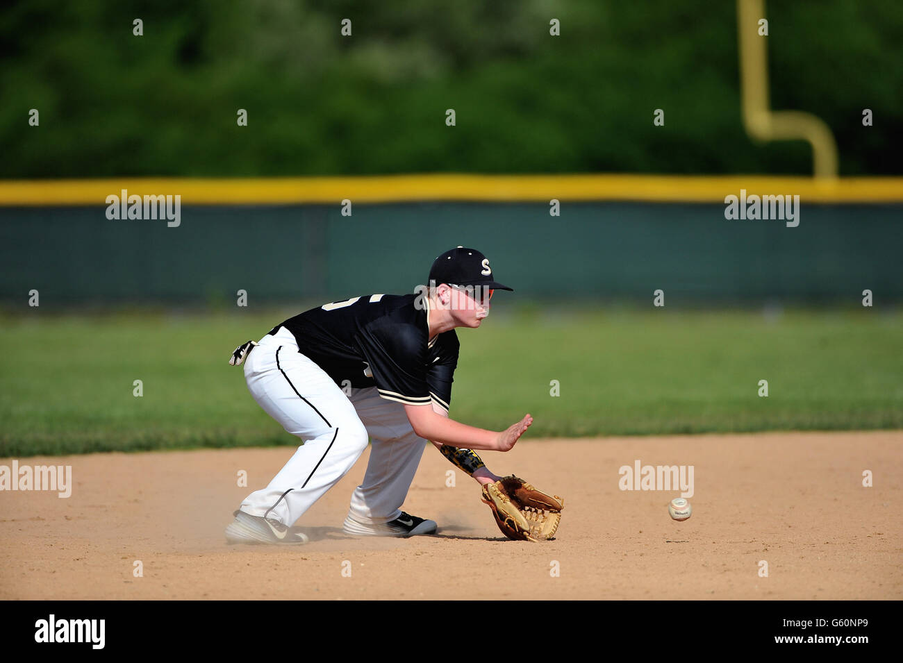 High school shortstop staying low to the ground to field grounder ...