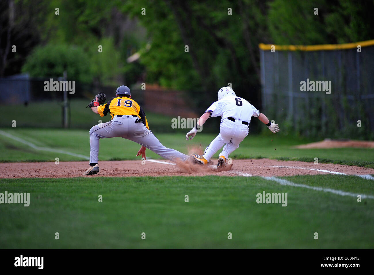On what appeared to be a run scoring single, a batter/base runner leaps ...