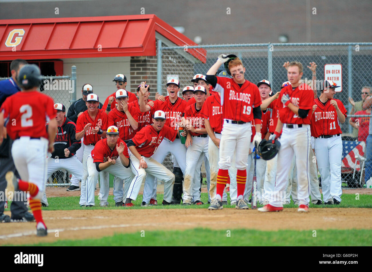 Players celebrate while forming a reception for their teammate as he ...