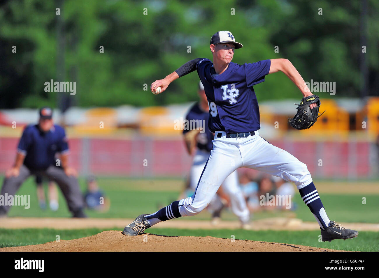 Right-handed pitcher delivering a pitch to a waiting hitter during a ...