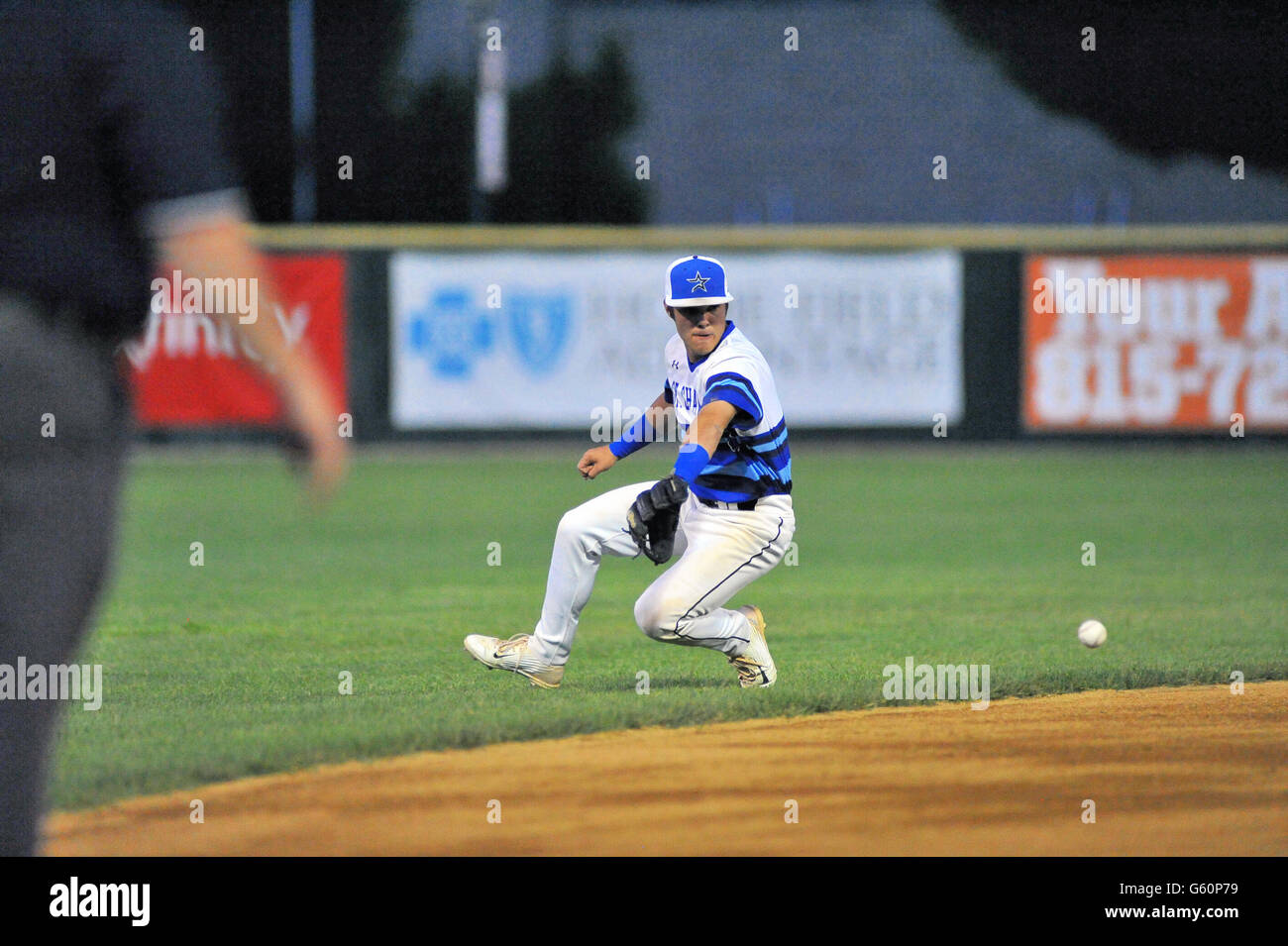 High school Shortstop going deep in the hole to make a sliding stop on ...