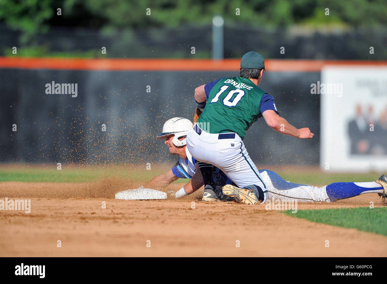 Base runner dives in safely to second base with a successful steal ...