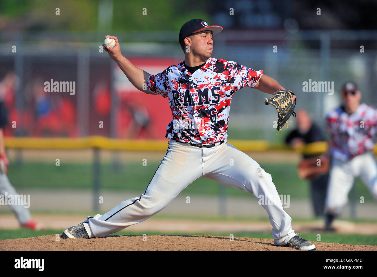 Right-handed pitcher delivering a pitch to a waiting hitter during a ...