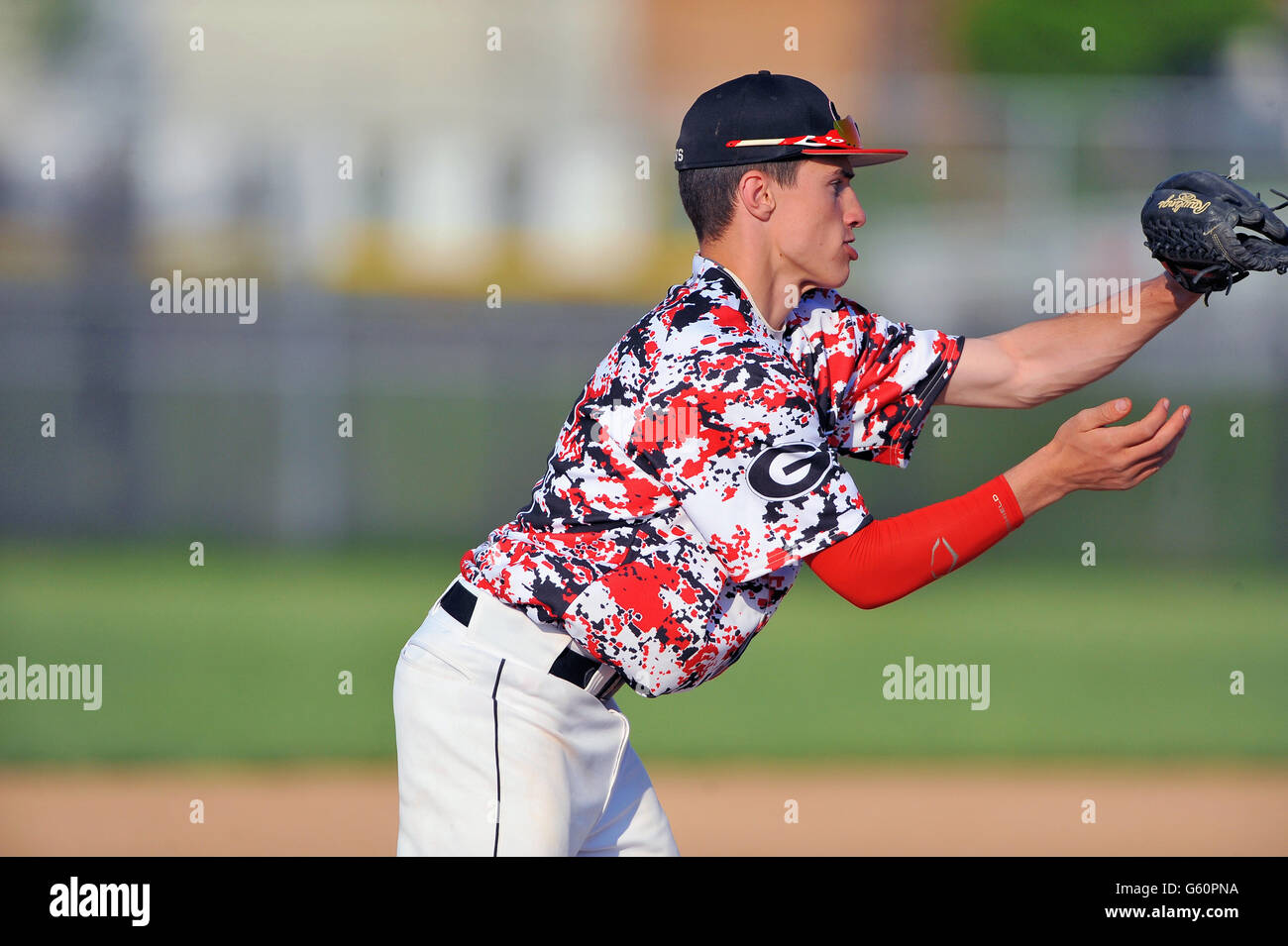 Third baseman gloving a hard hit ground ball before throwing on to ...