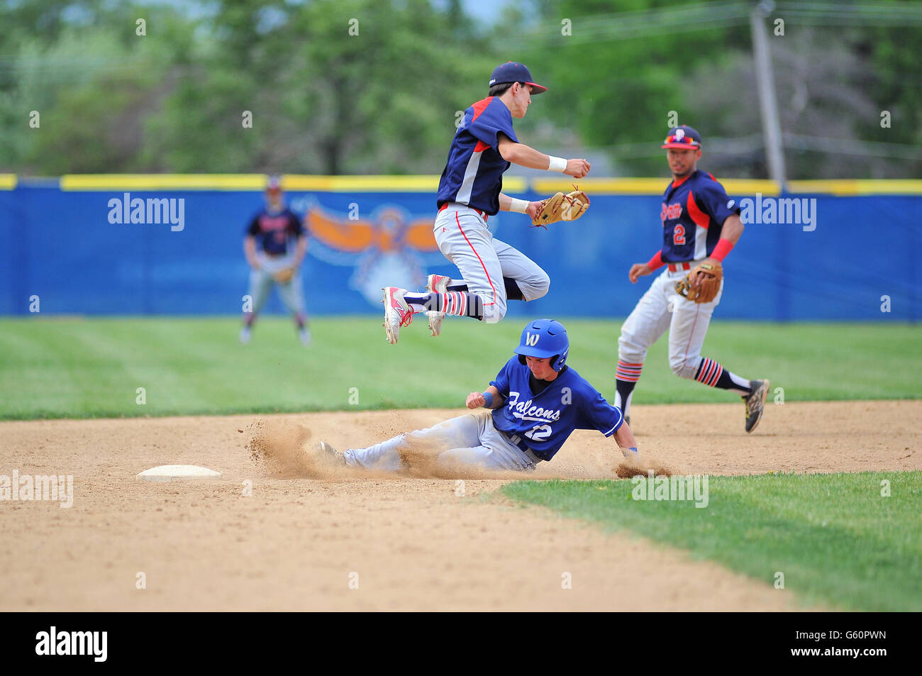 A high school shortstop going airborne in an effort to snag a high ...