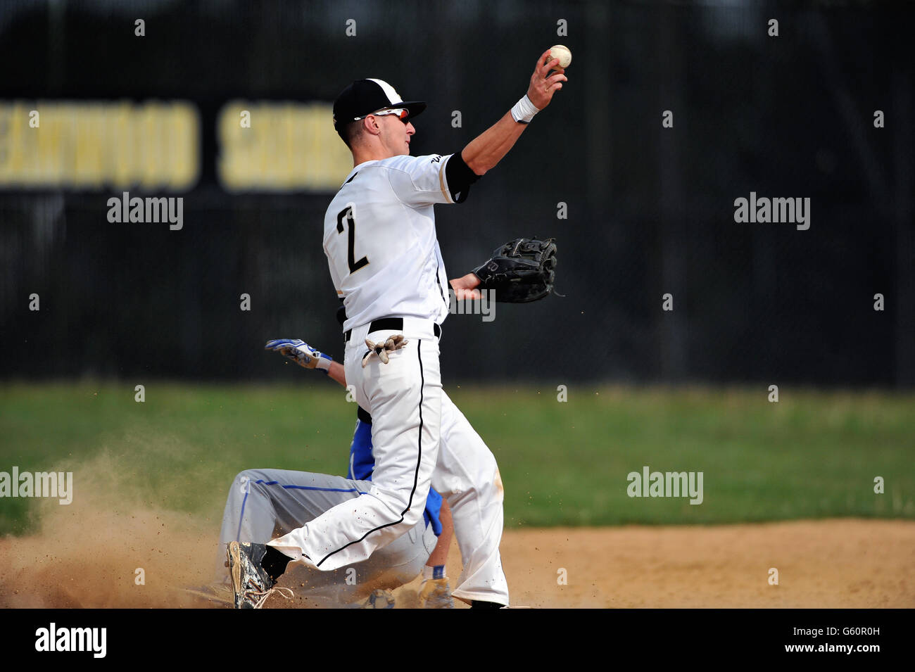 A second baseman relaying on to first base in an effort to turn a ...