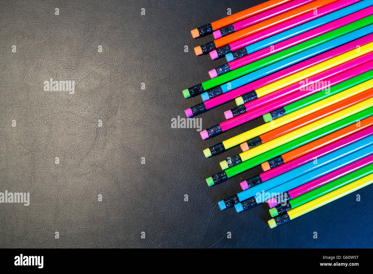 Colored pencils on a black background Stock Photo - Alamy