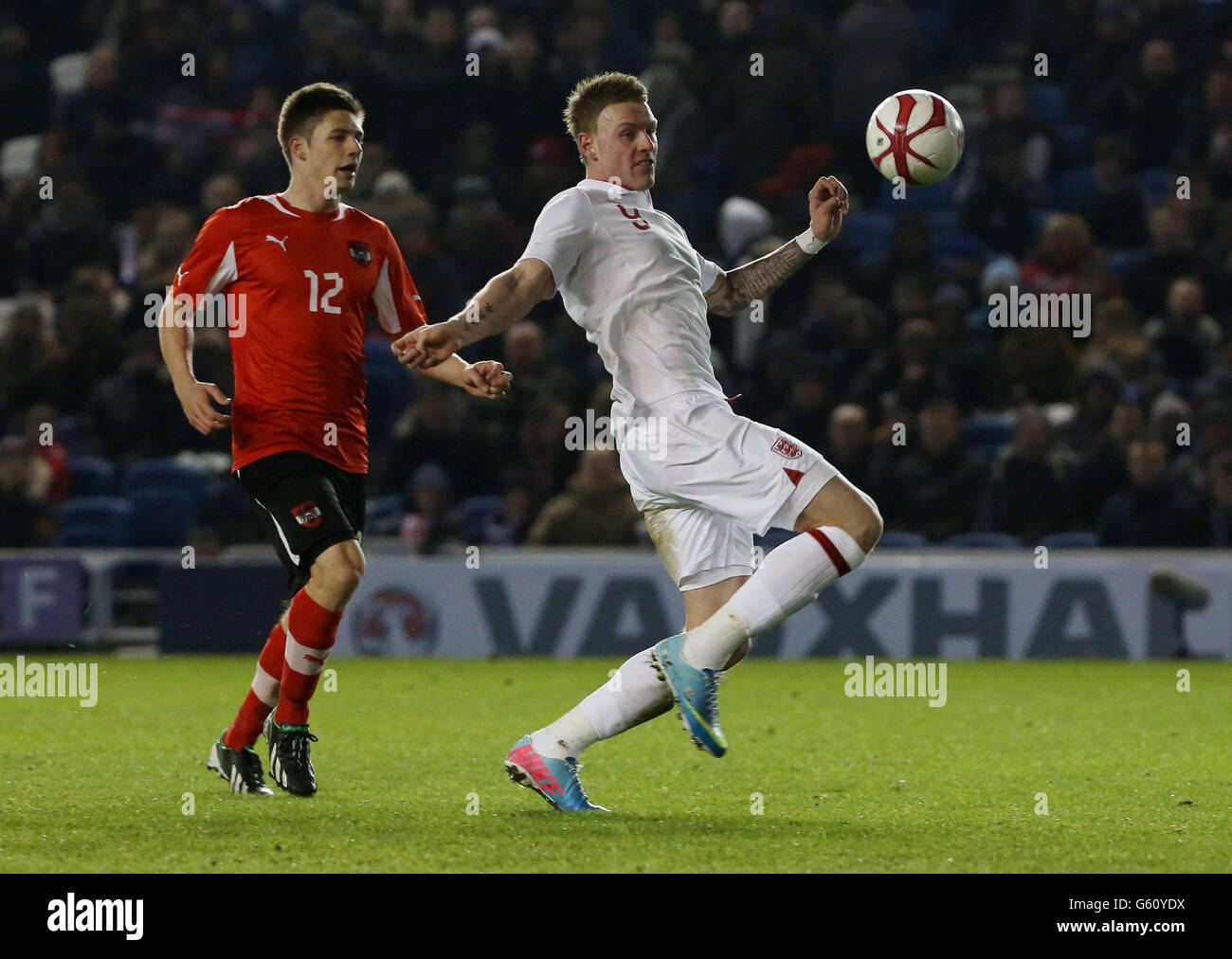 England's Connor Wickham (right)stretches for the ball past Austria's ...