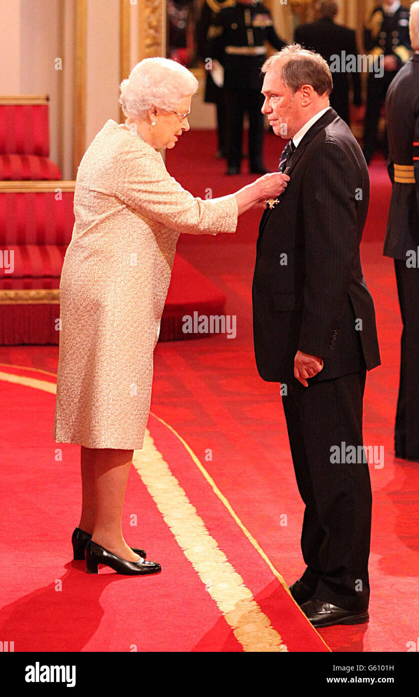 Malcolm Brown receiving his Member of the British Empire (MBE) medal ...