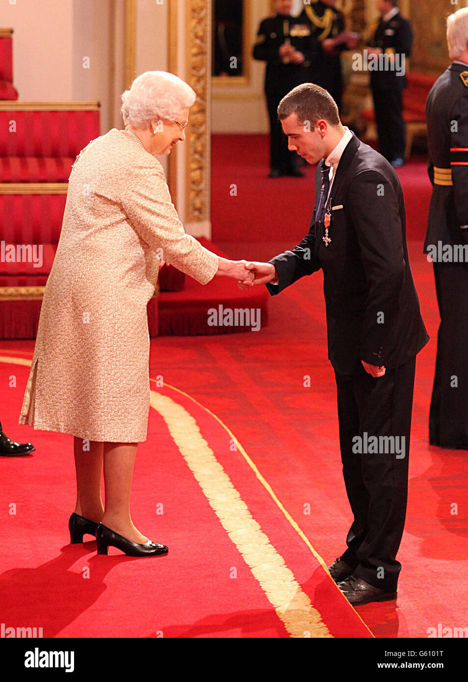 Paralympic swimmer Josef Craig receiving his Member of the British ...