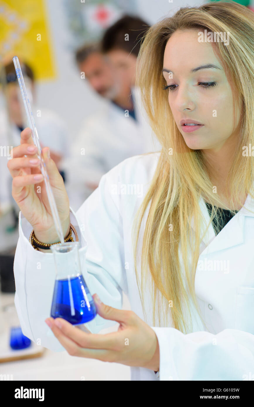 Female scientist holding glass flask Stock Photo - Alamy