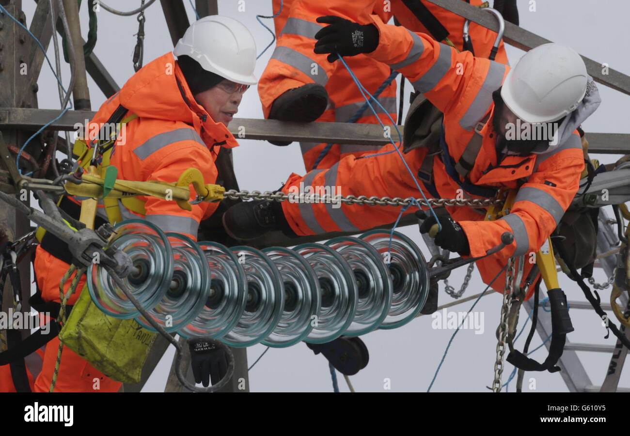 Workers are pictured on a damaged pylon in Kintyre, Scotland as ...
