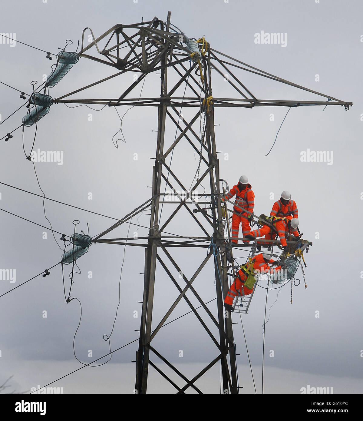 Workers are pictured on a damaged pylon in Kintyre, Scotland as ...