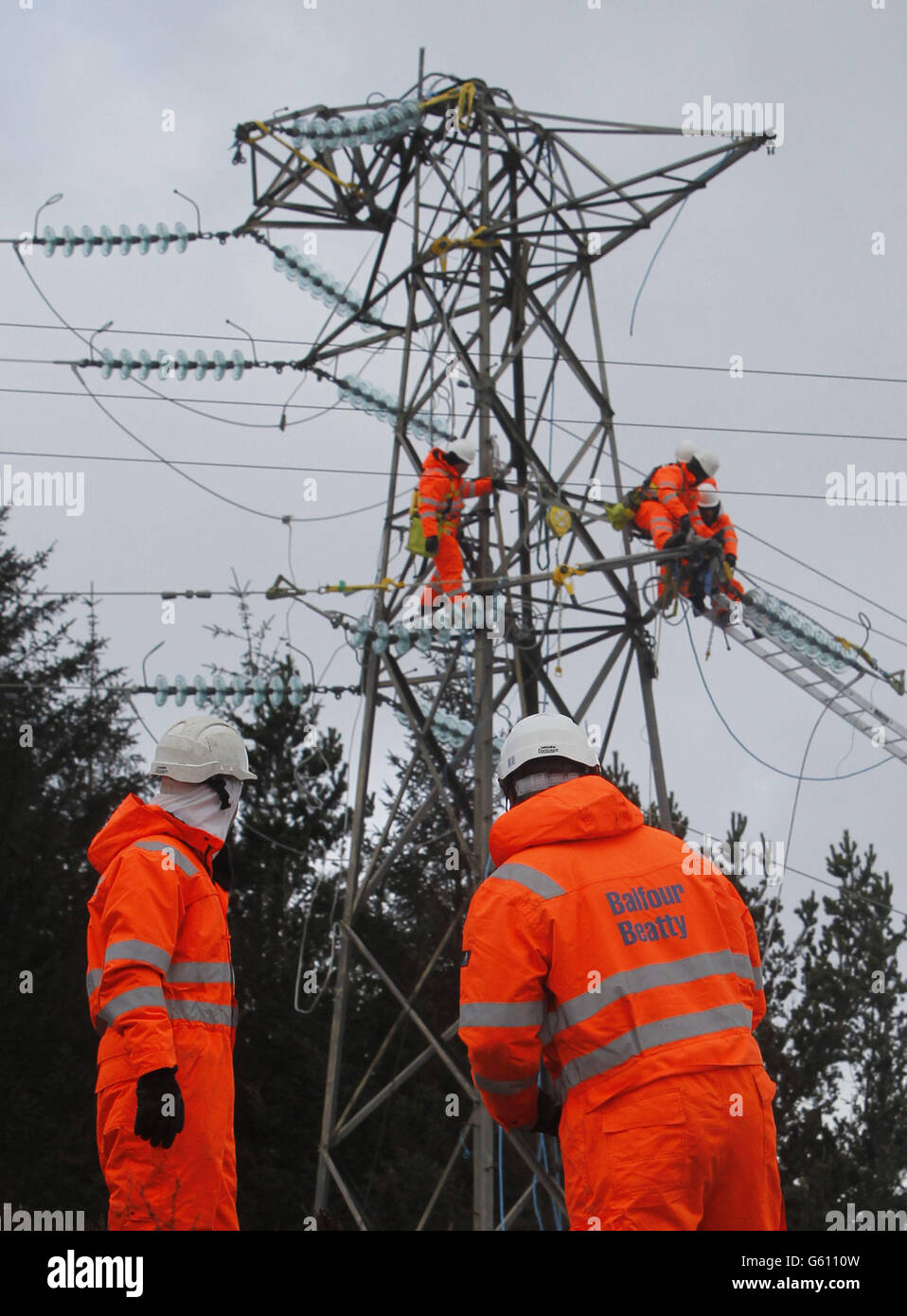 Workers are pictured on a damaged pylon in Kintyre, Scotland as ...