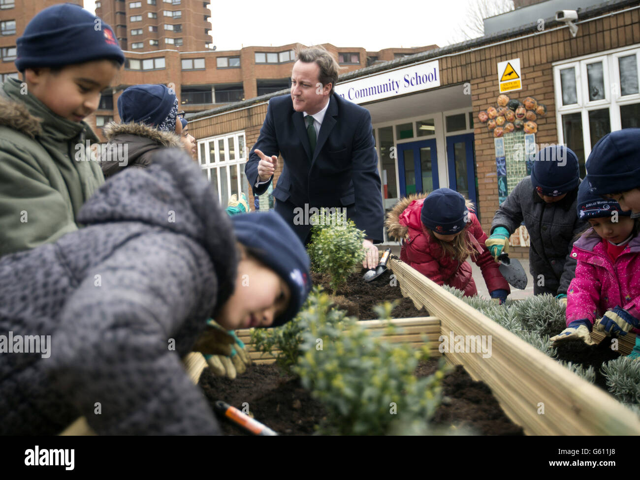 Prime Minister David Cameron, centre, helps school children plant box ...