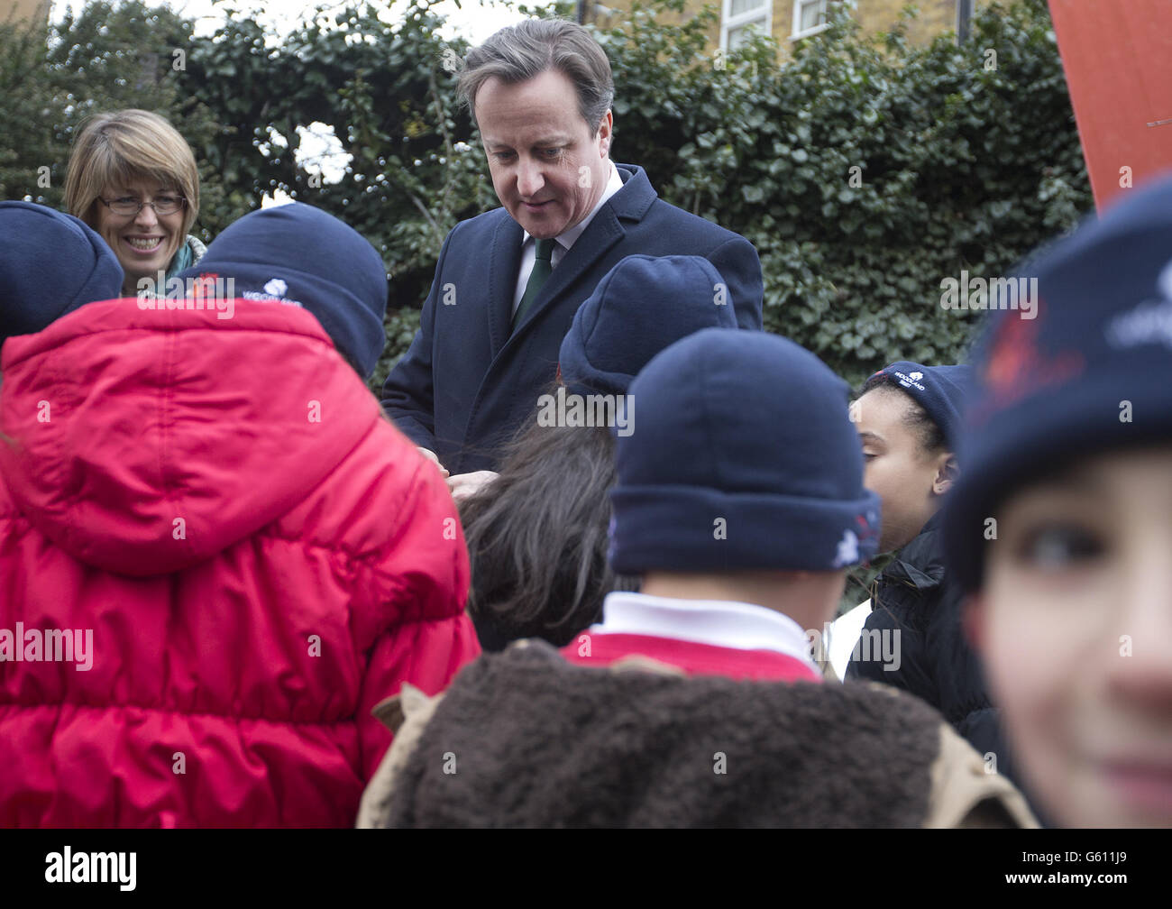 Prime Minister David Cameron, centre, speaks to school children during ...