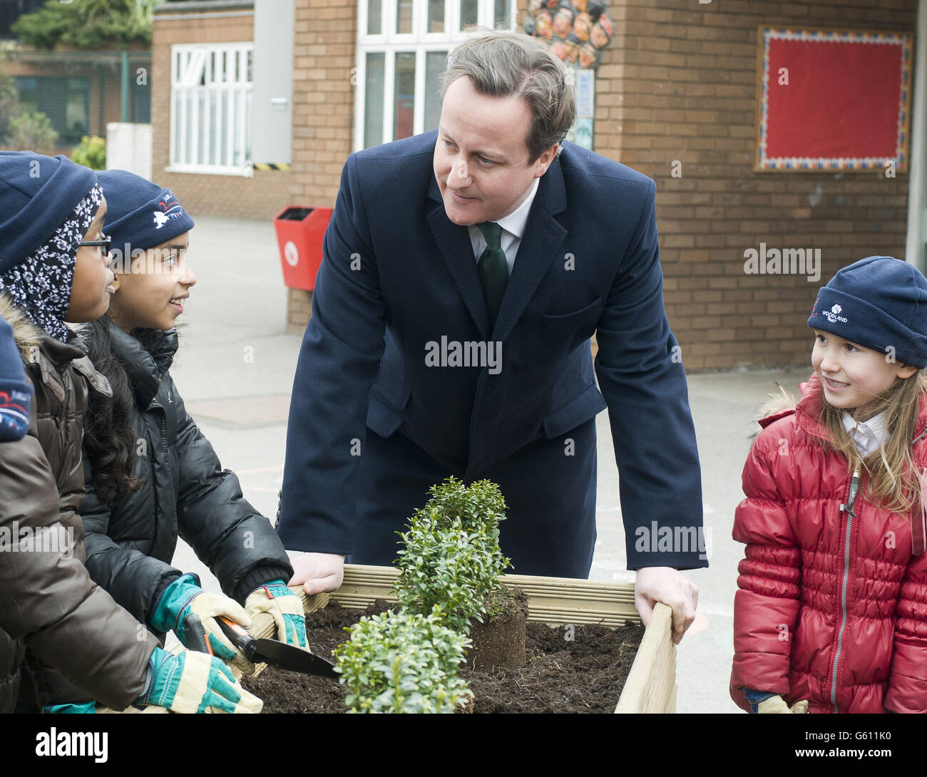 Prime Minister David Cameron, centre, helps school children plant box ...