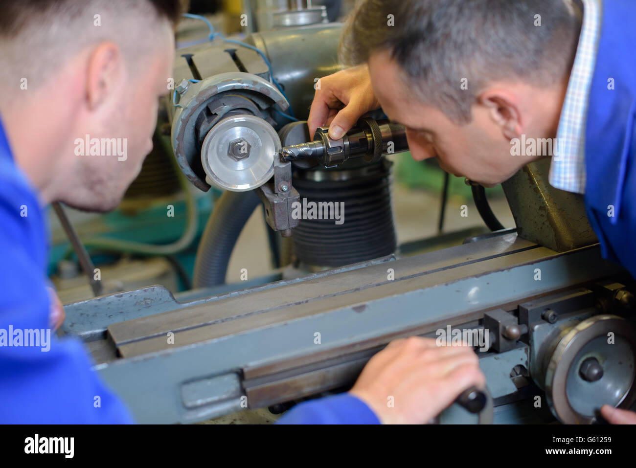 men fixing machine Stock Photo - Alamy