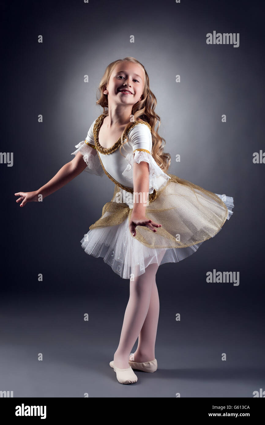 Smiling little ballerina posing looking at camera Stock Photo - Alamy